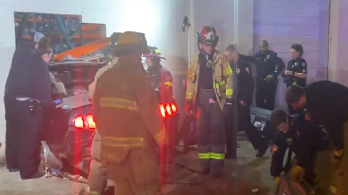 Firefighters rescue man trapped in car after hitting building ...